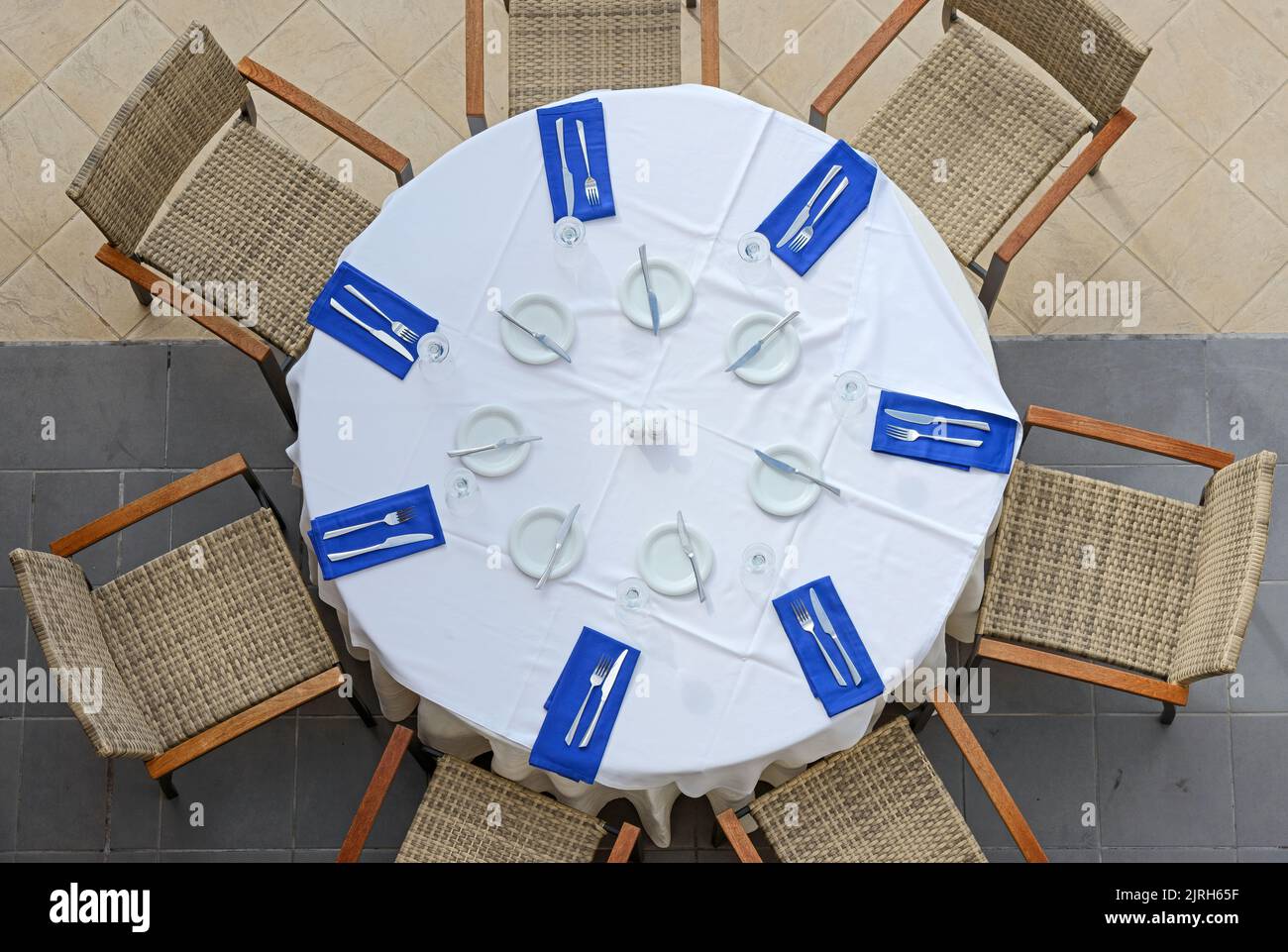 High angle view of table with initial setting and armchairs around it ...