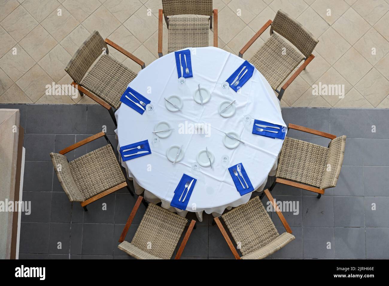 High angle view of table with initial setting and armchairs around it ...