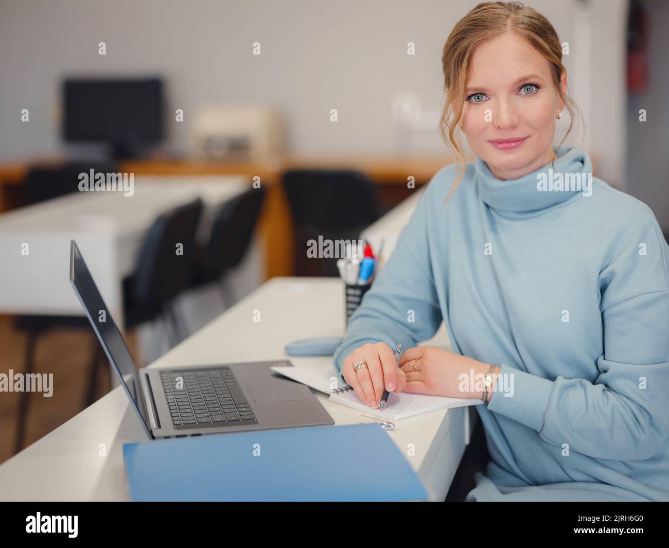 Business woman in blue dress working in office. Online business, young ...