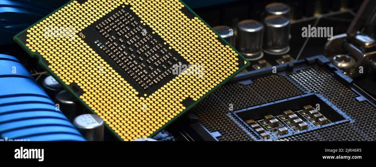Detail of CPU Chip over socket of a modern computer motherboard. Electronic small component ...