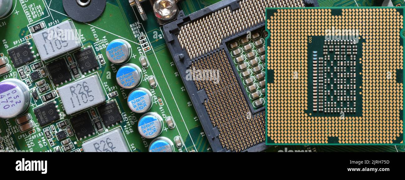 Detail of CPU Chip over socket of a modern computer motherboard. Electronic small component ...