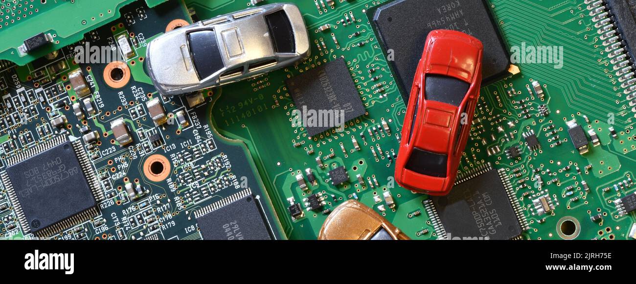 Toy cars on electronic board and microchip. Conceptual image for ...