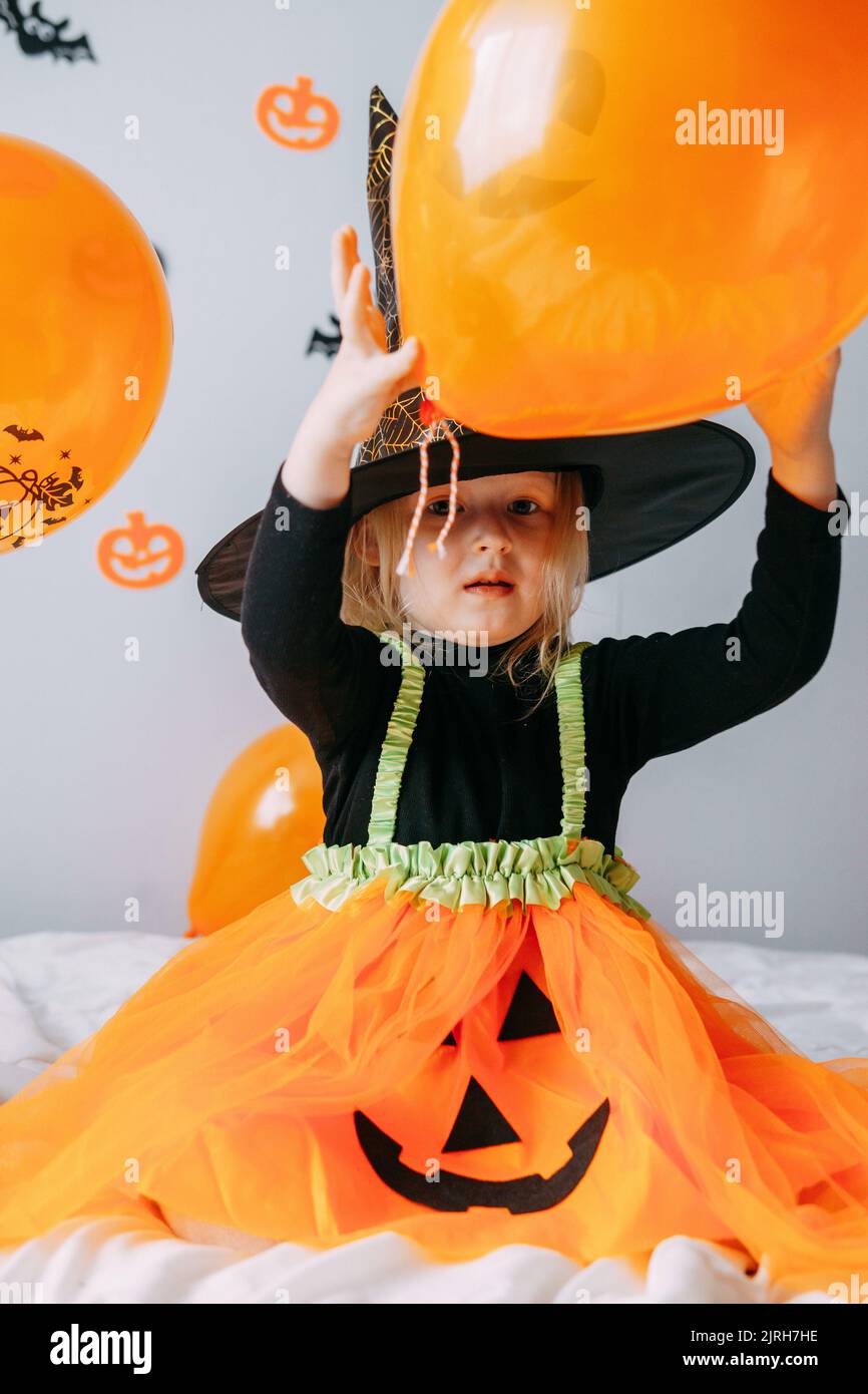 Children's Halloween - a girl in a witch hat and a carnival costume ...