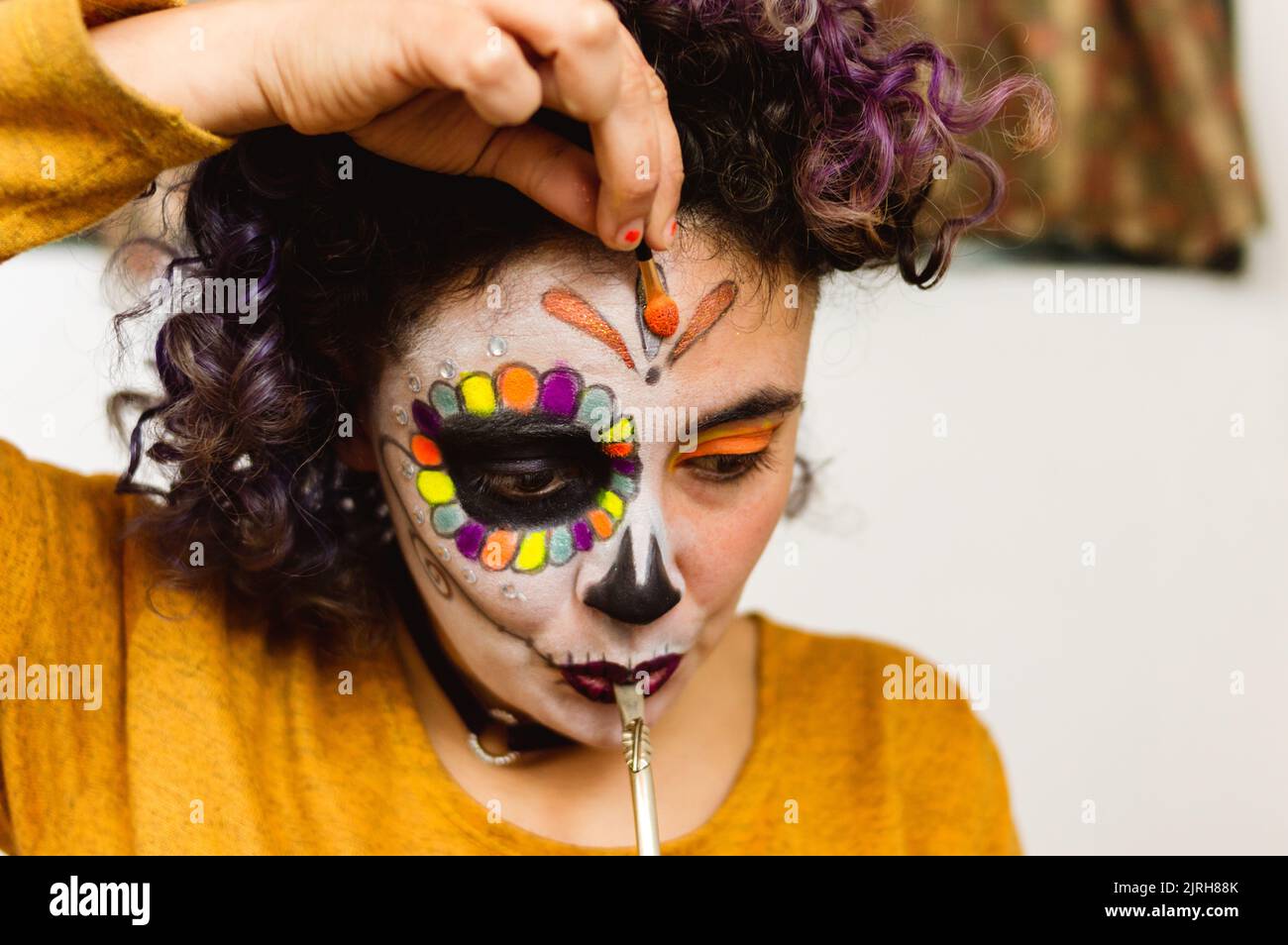 Calm young latin caucasian argentinian woman drinking mate in her room while applying La ...