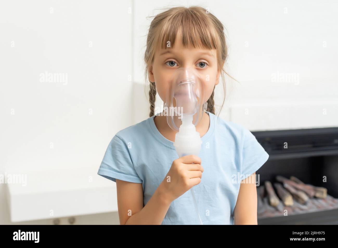 Kid girl makes inhalation with a nebulizer. sick child holding ...