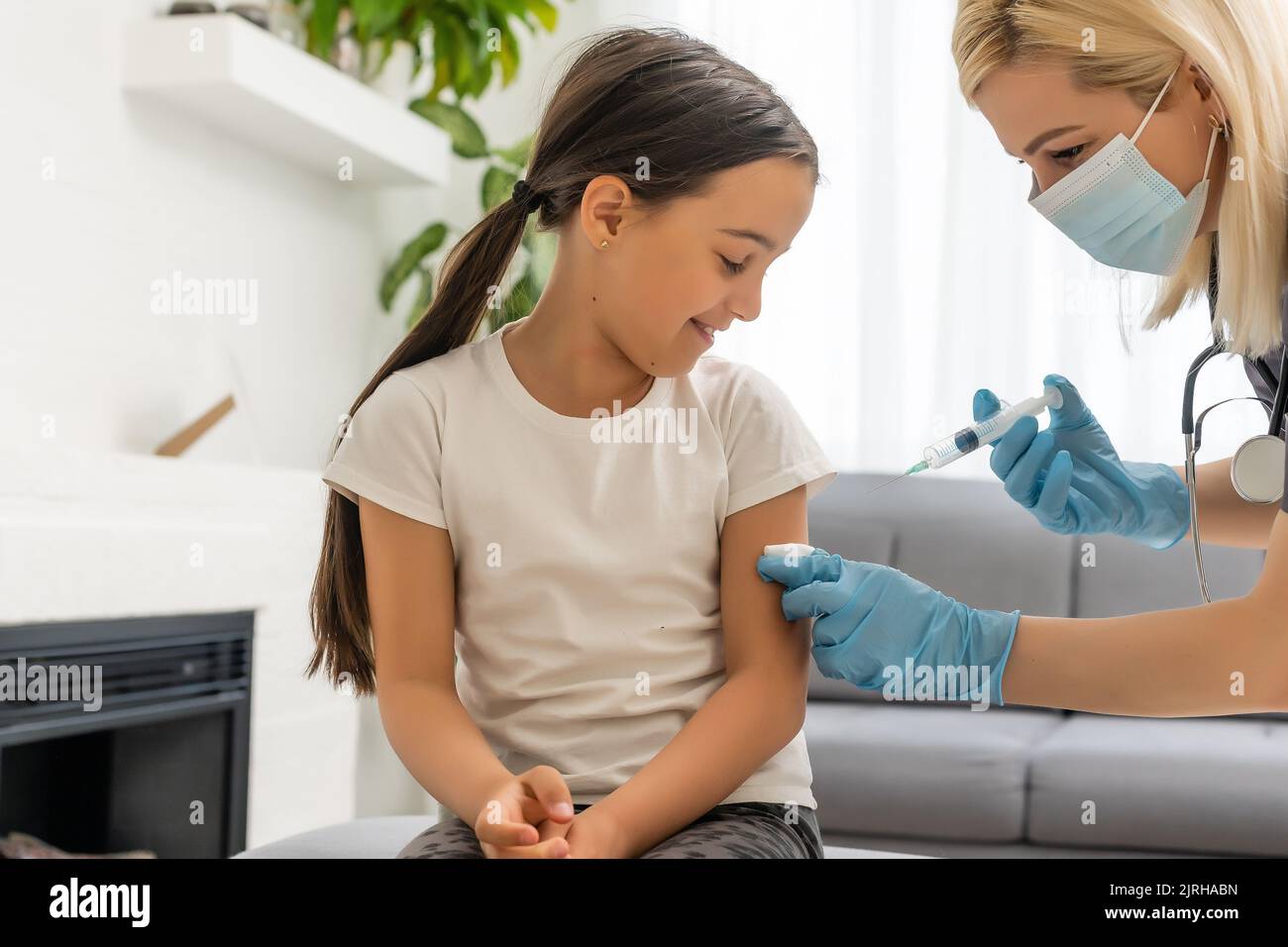 nurse giving vaccination injection to little girl patient Stock Photo ...