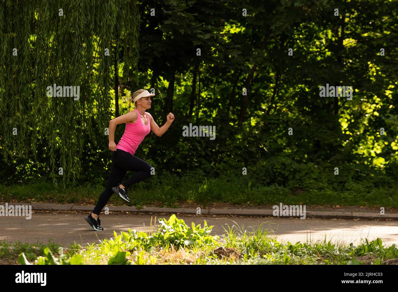 Running woman. Female Runner Jogging during Outdoor Workout in a Park ...