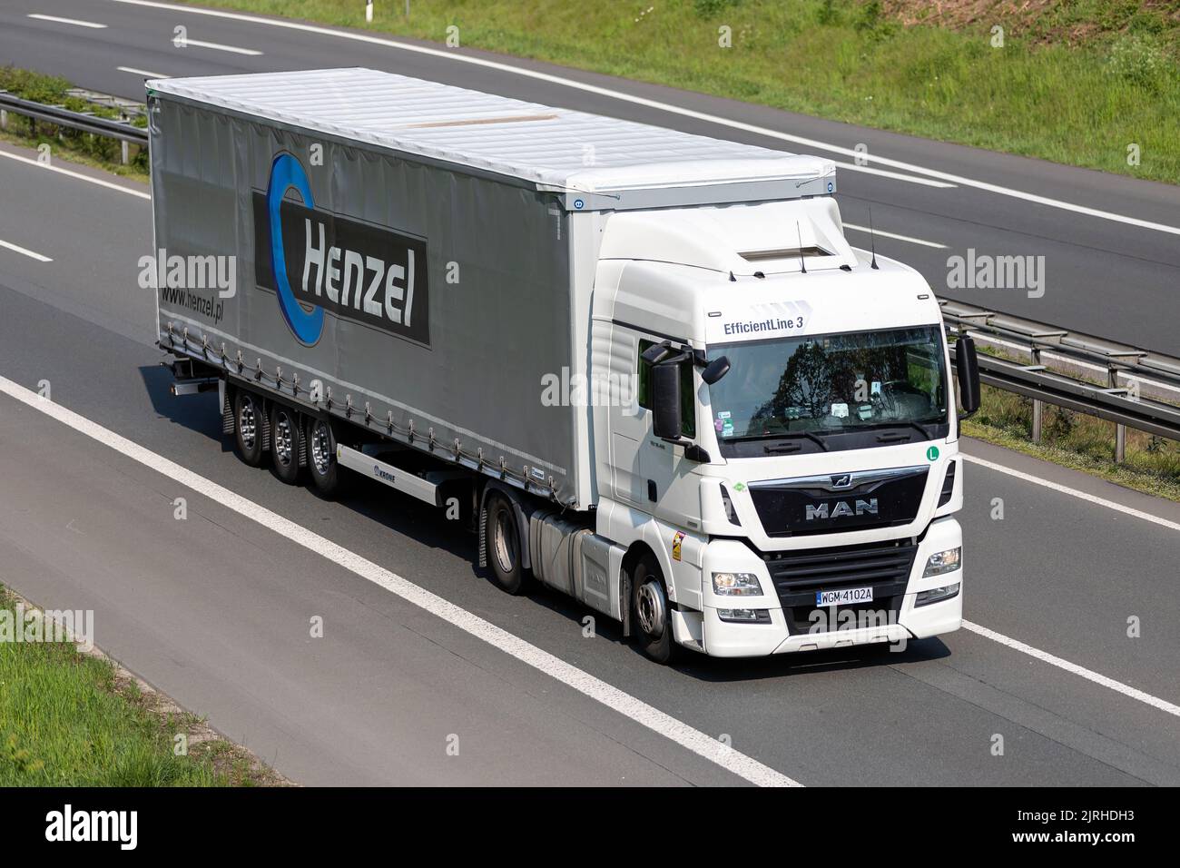 MAN TGX truck with Henzel curtainside trailer on motorway Stock Photo ...