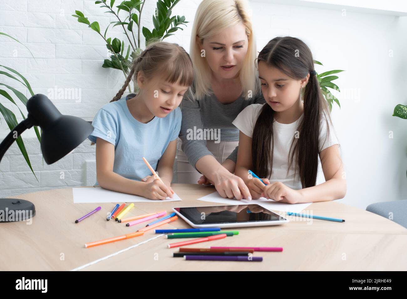 Cute little schoolgirls. Young students doing his homework. Education ...