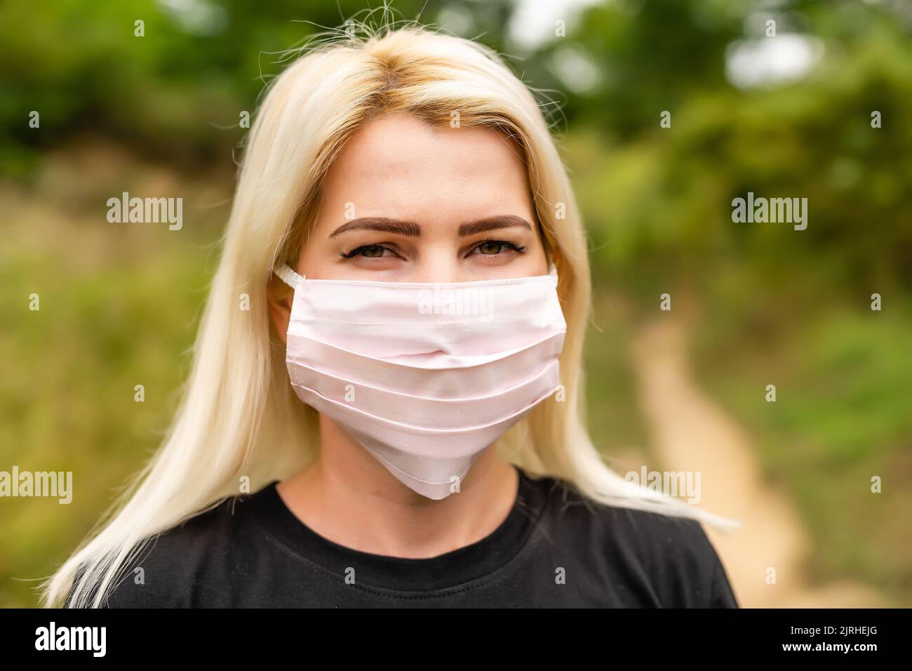 Beautiful caucasian young woman with disposable face mask. Protection ...