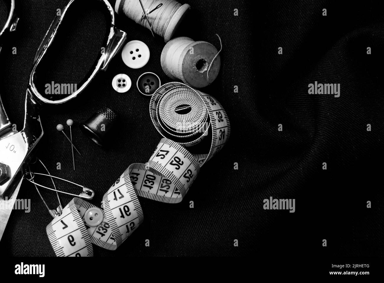 Retro tools for cutting and sewing. Needle with thread, thimble, sewing ...