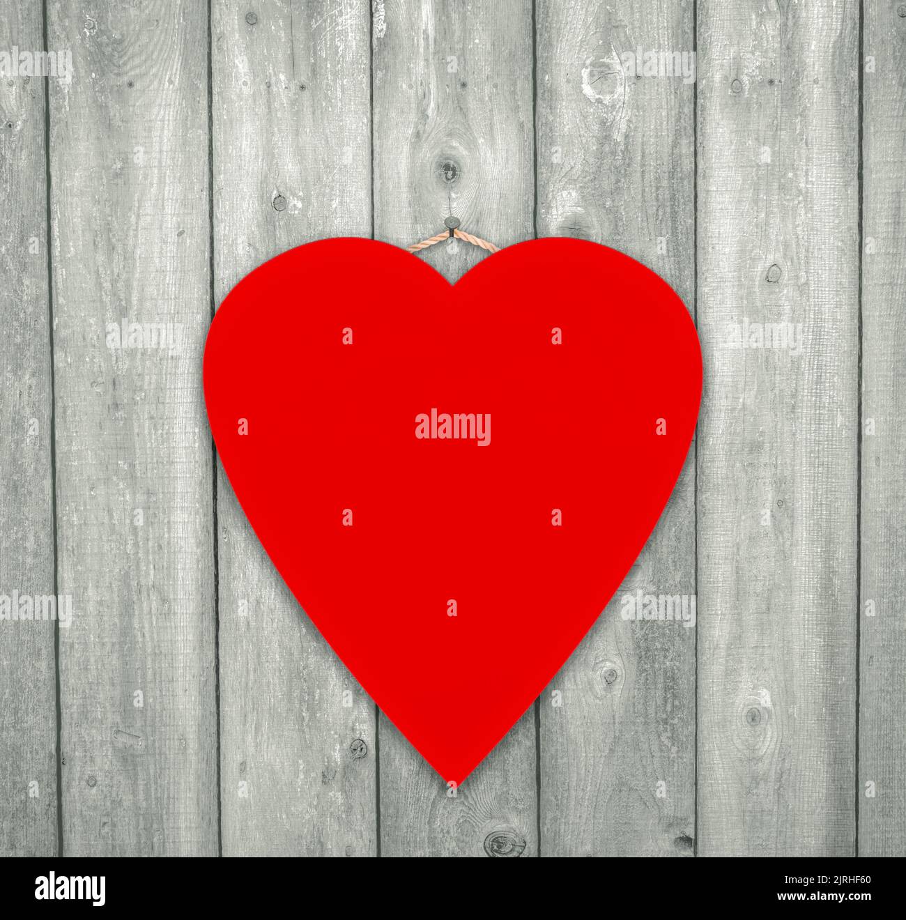 Red valentine heart a symbol of love hanging on a white washed wooden ...