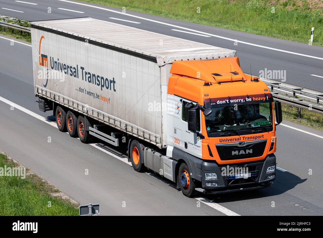 Universal Transport MAN TGX truck with curtainside trailer on motorway ...