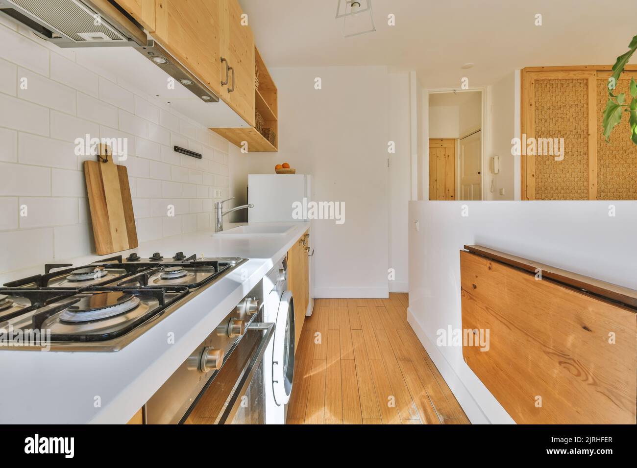 Studio apartment with white walls and open plan kitchen with sofa in ...