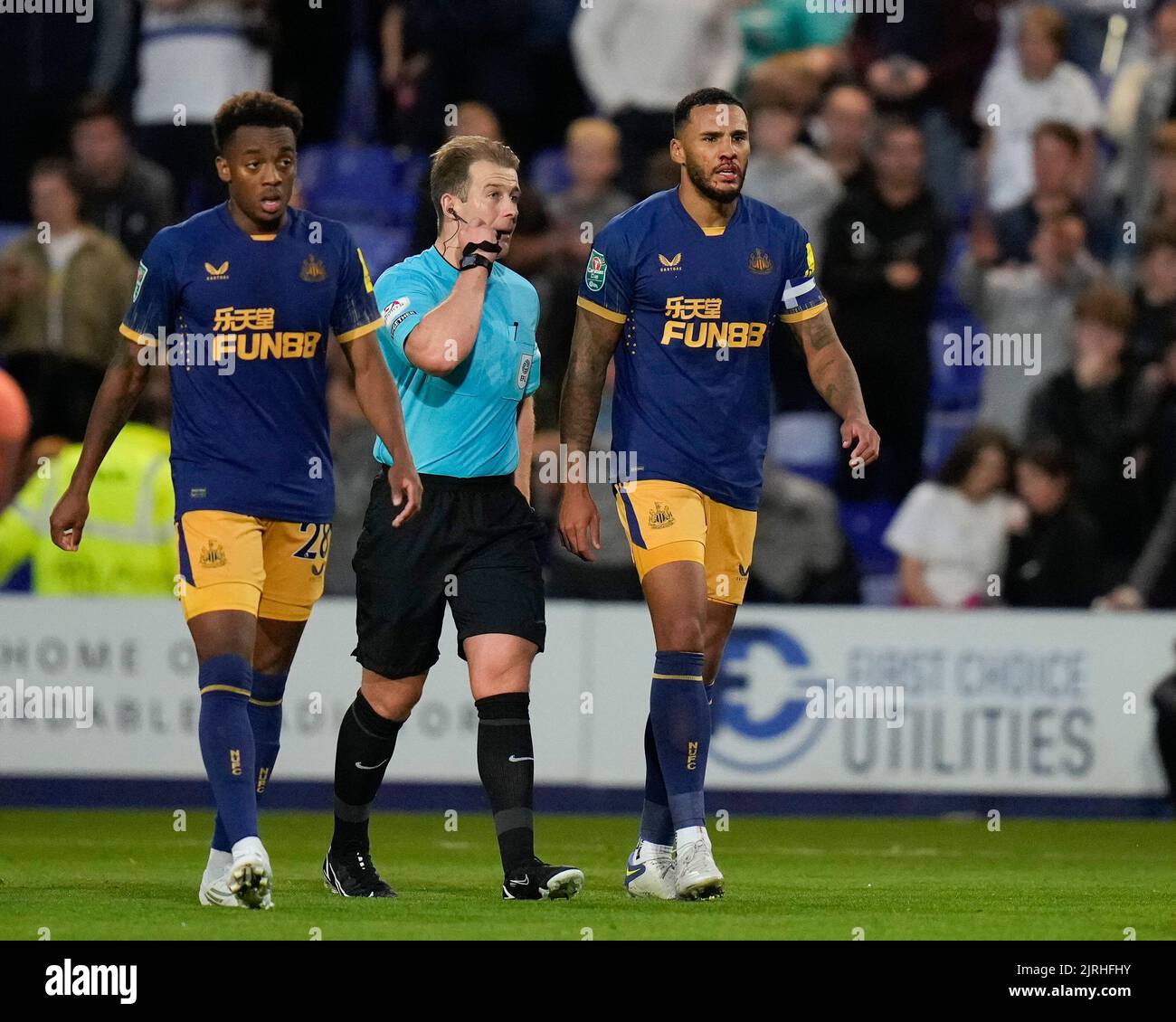 Referee Anthony Backhouse escorts Jamaal Lascelles #6 of Newcastle ...