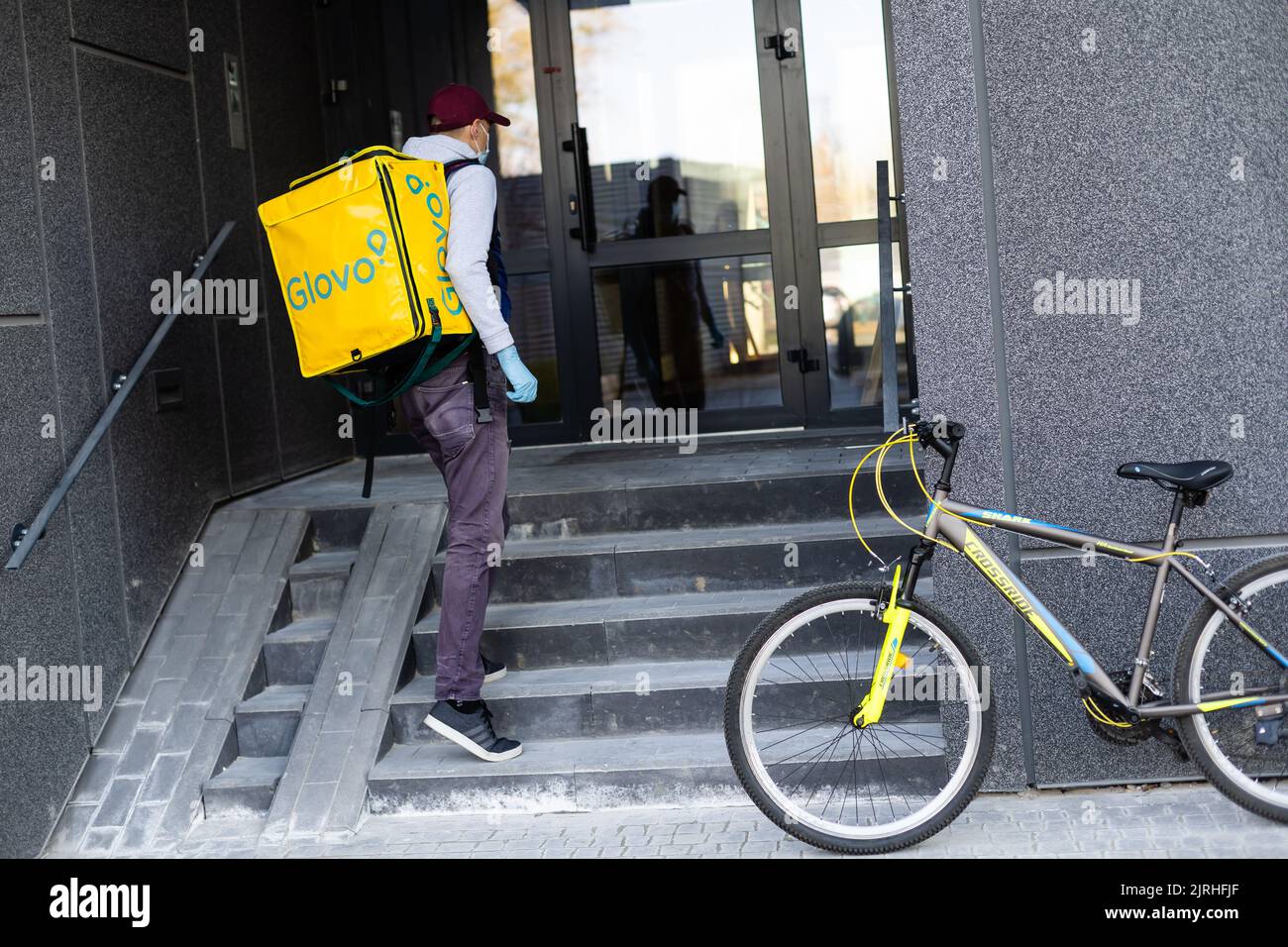 KIEV, UKRAINE - 28 April, 2021: Glovo delivery boy with famous yellow ...