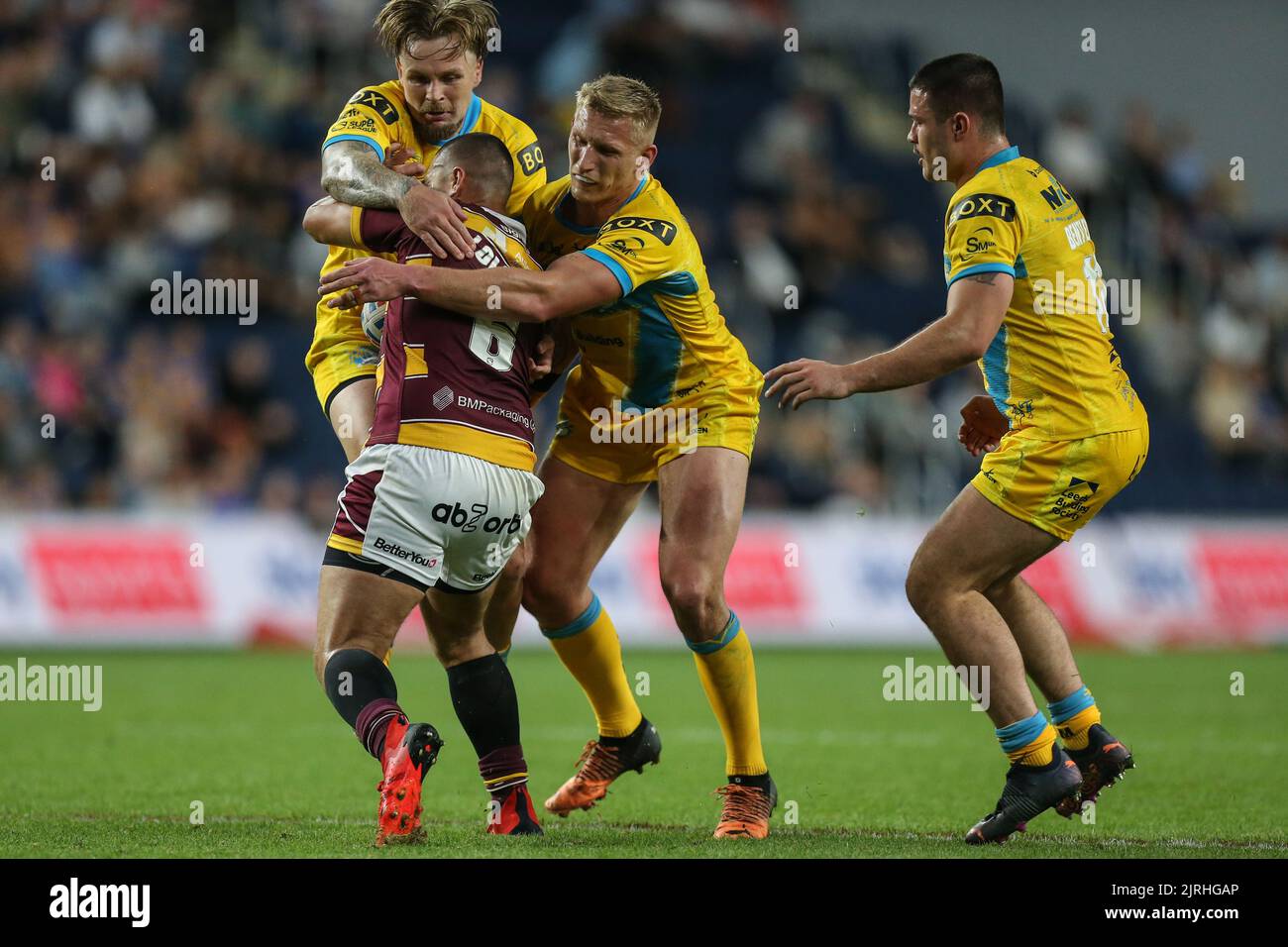 Danny Levi #9 of Huddersfield Giants is stopped by the Leeds defence ...