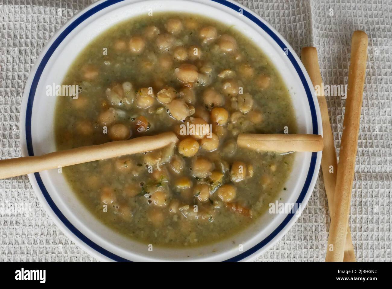 Chickpea soup with bread sticks Stock Photo - Alamy