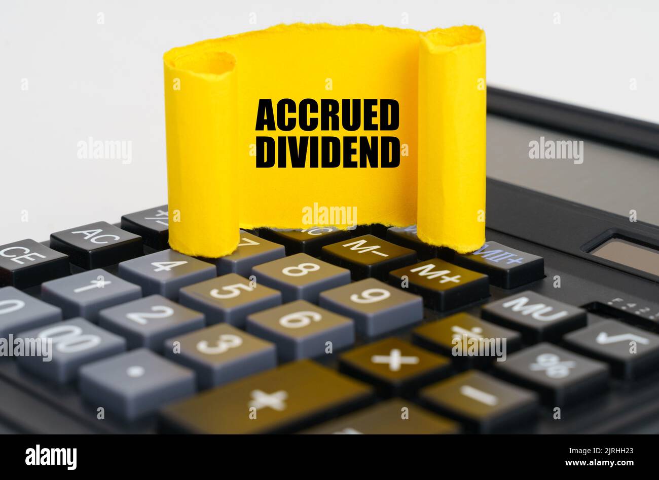 Business concept. On the calculator is a yellow, twisted paper plate ...