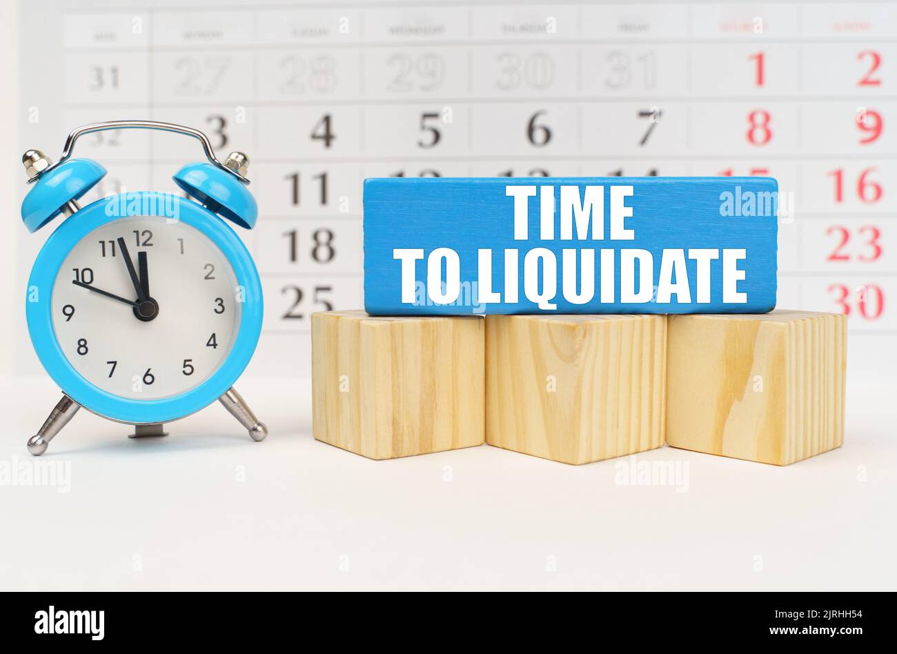 Time concept. Against the background of the calendar is an alarm clock ...