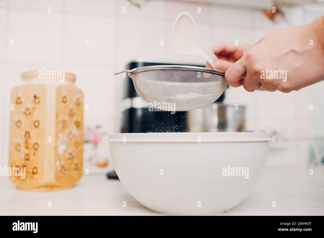 Pastry chef sift pours flour makes cake. Cooking and preparing dessert ...