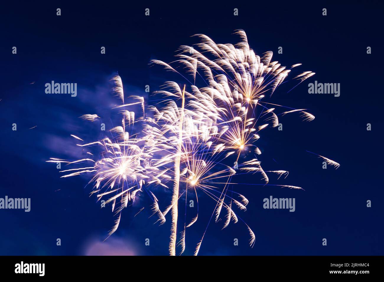 Bright, beautiful blue fireworks in the night sky Stock Photo - Alamy