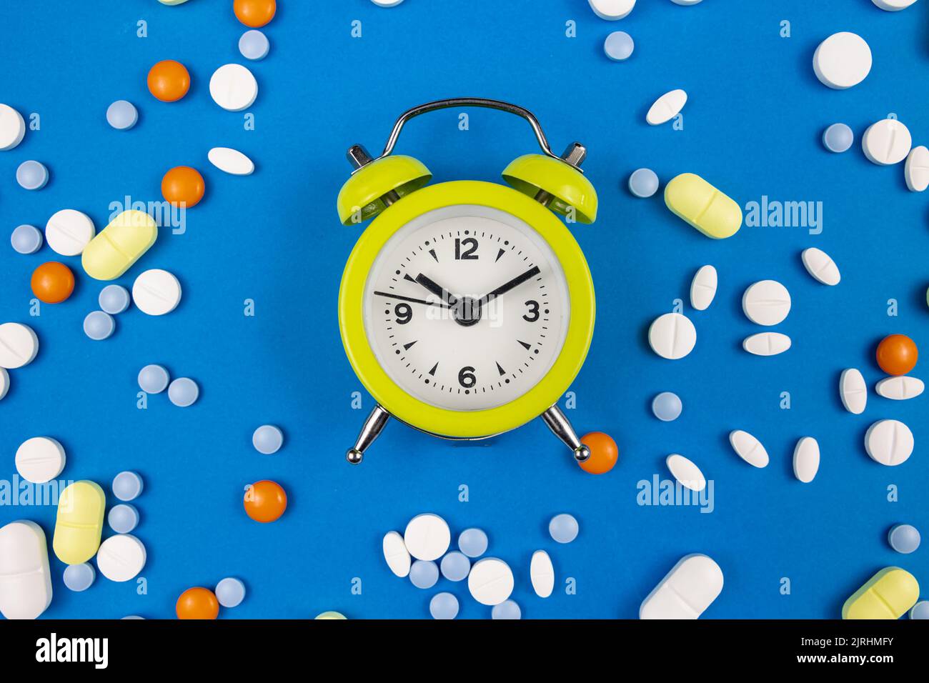 Medical pills with alarm clock. Taking pills or capsules on time ...