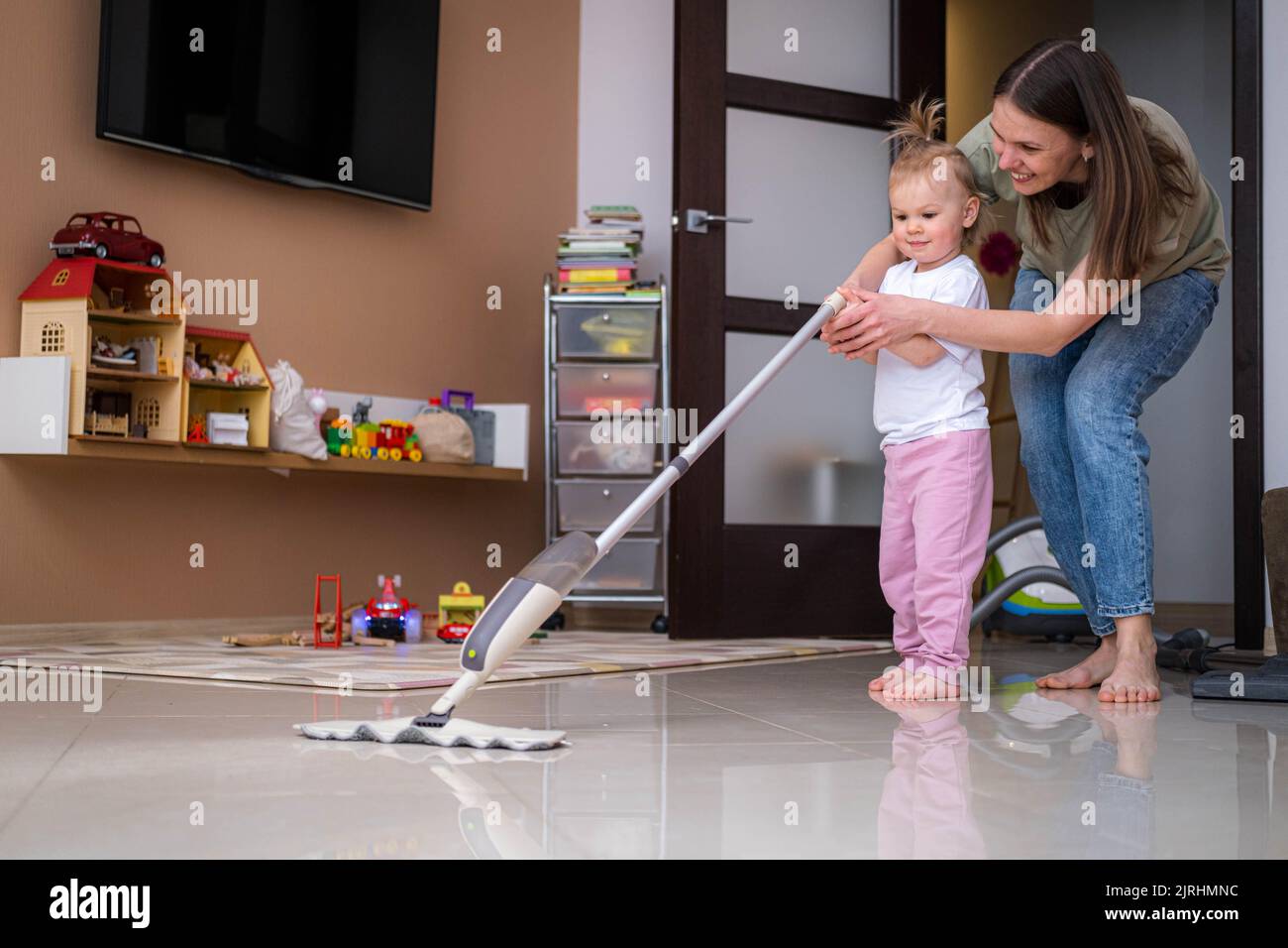 little daughter cleaning in the house, child dusting, Cute little ...