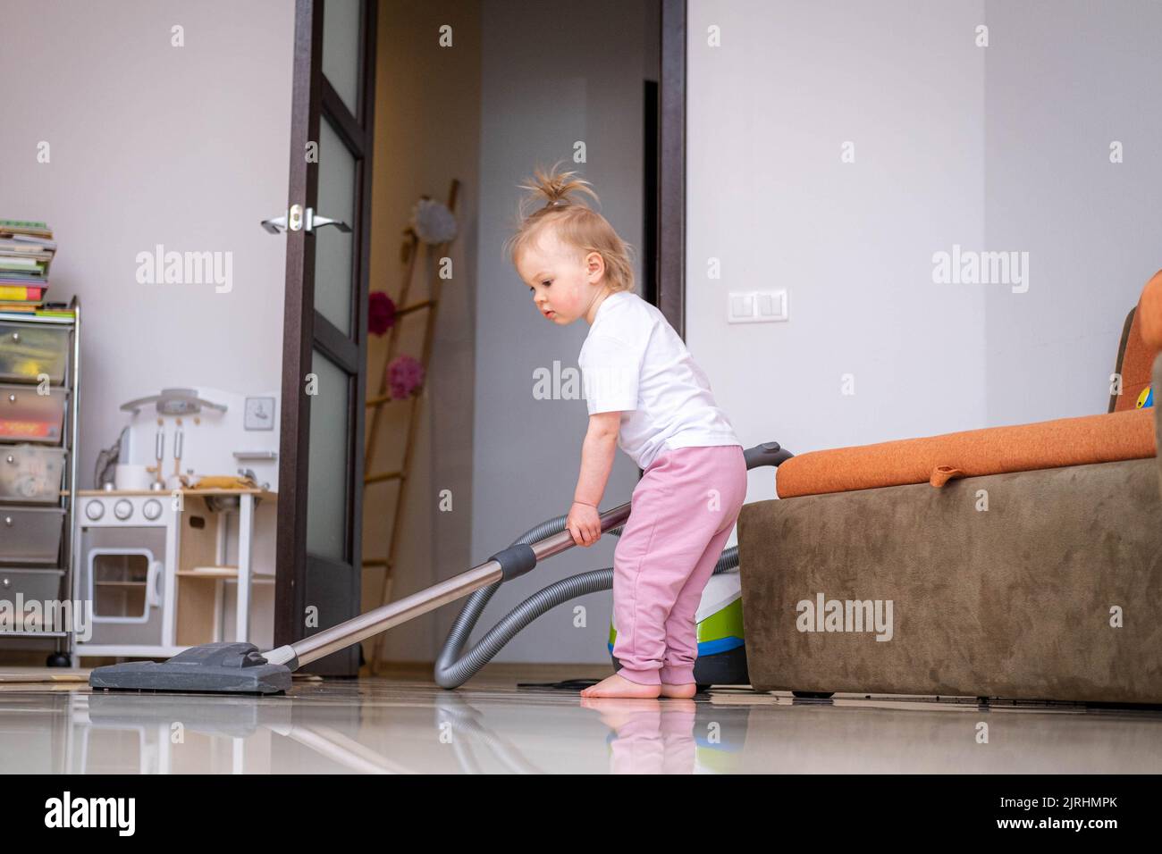 little daughter cleaning in the house, child dusting, Cute little ...