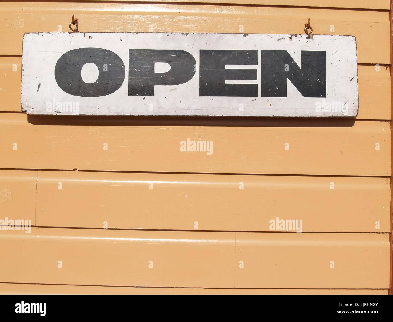 Word OPEN on sign in black and white attached to exterior wall Stock ...
