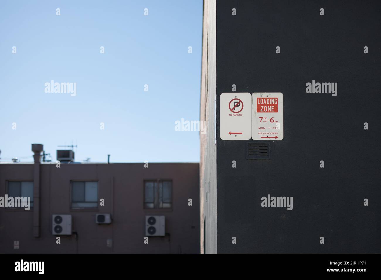 A closeup of warning messages with signs on a building wall Stock Photo ...