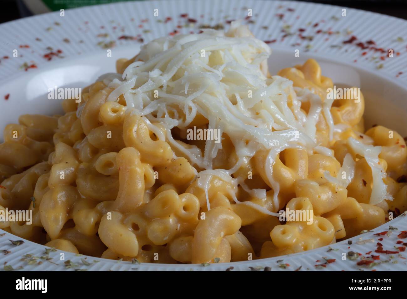 Mac and cheese, american style macaroni pasta with cheesy sauce on dark ...