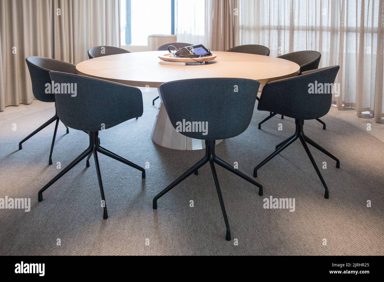 A business conference room with a table and chairs Stock Photo - Alamy