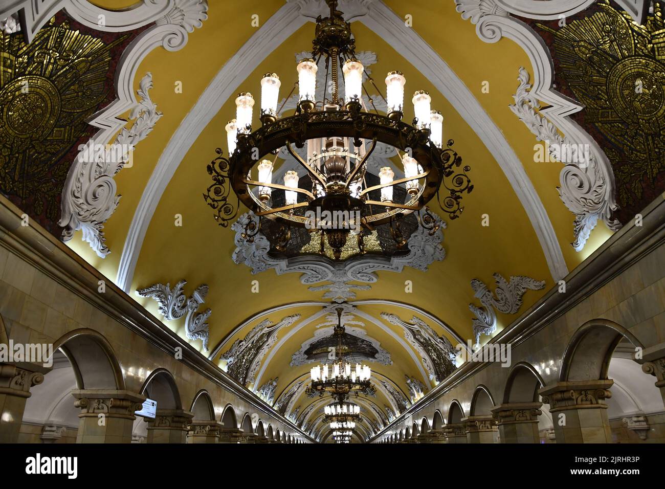 A beautiful shot of chandeliers and stucco ceilings in a Moscow metro ...