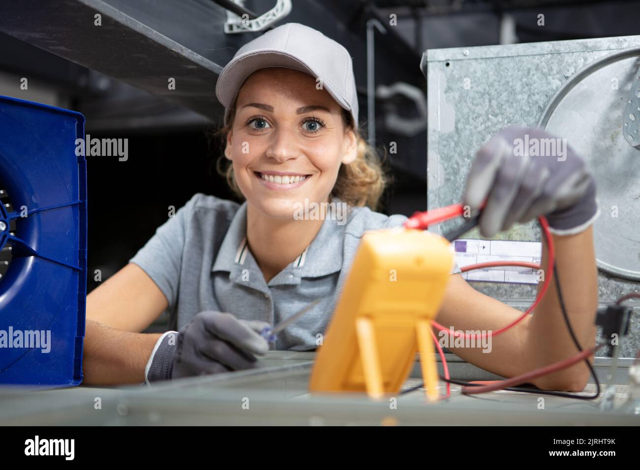 female electrician testing charge to spotlight Stock Photo - Alamy