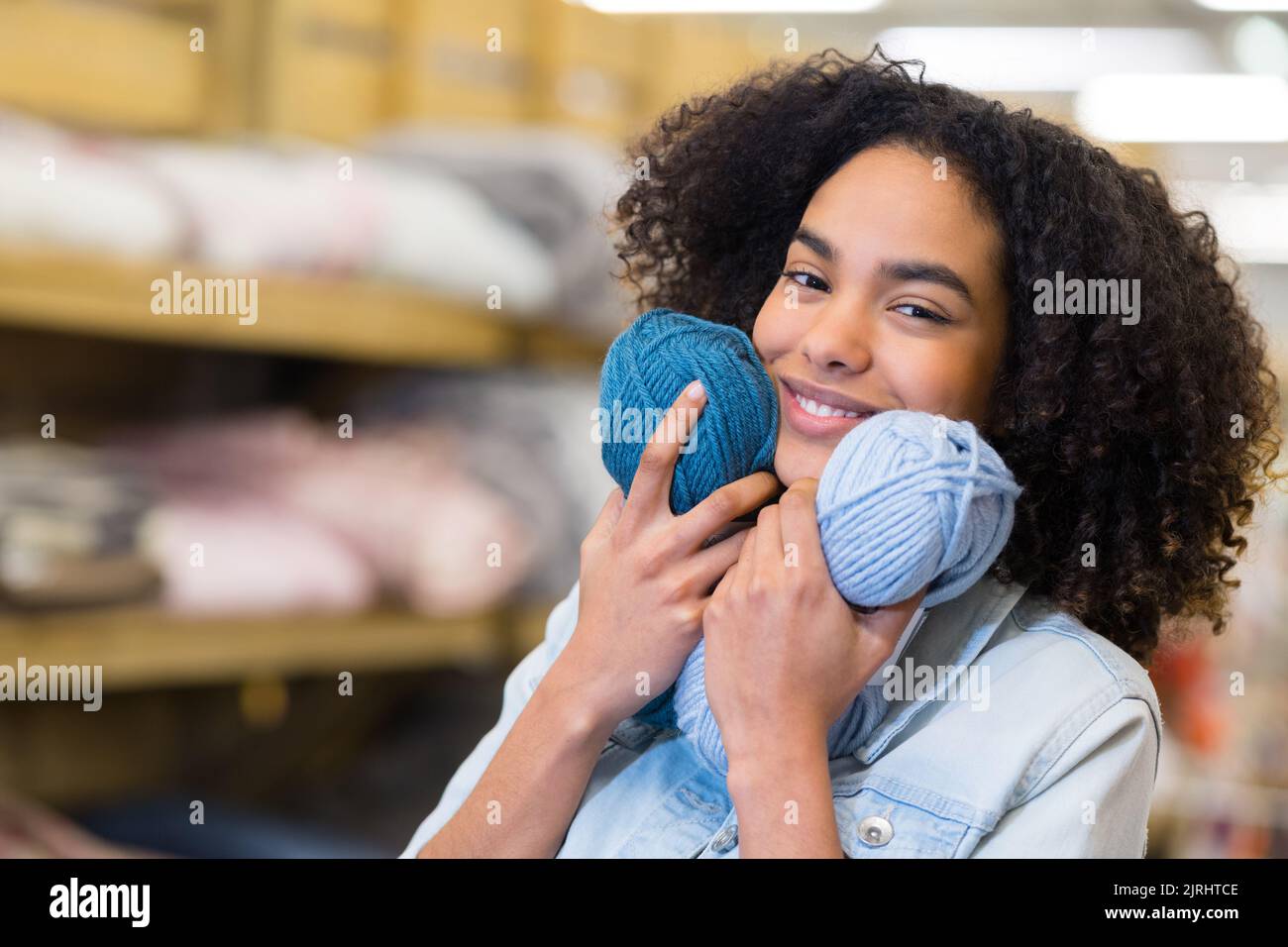 woman holding balls of wool close to her face Stock Photo - Alamy