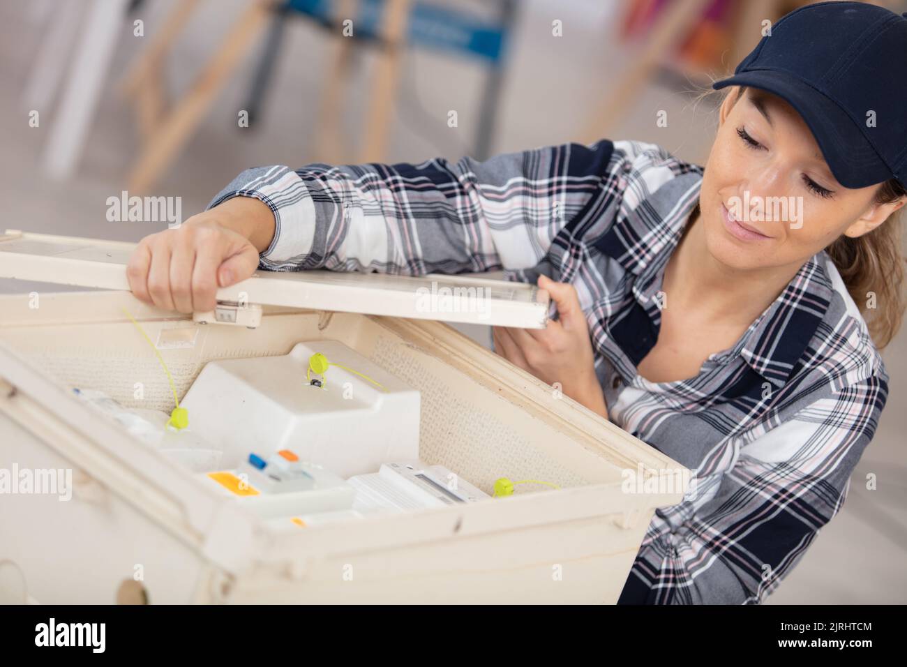 a woman is opening and fixing a printer Stock Photo - Alamy