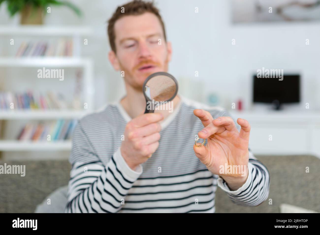 man holding a magnifying glass and magnifying viewer ring Stock Photo ...