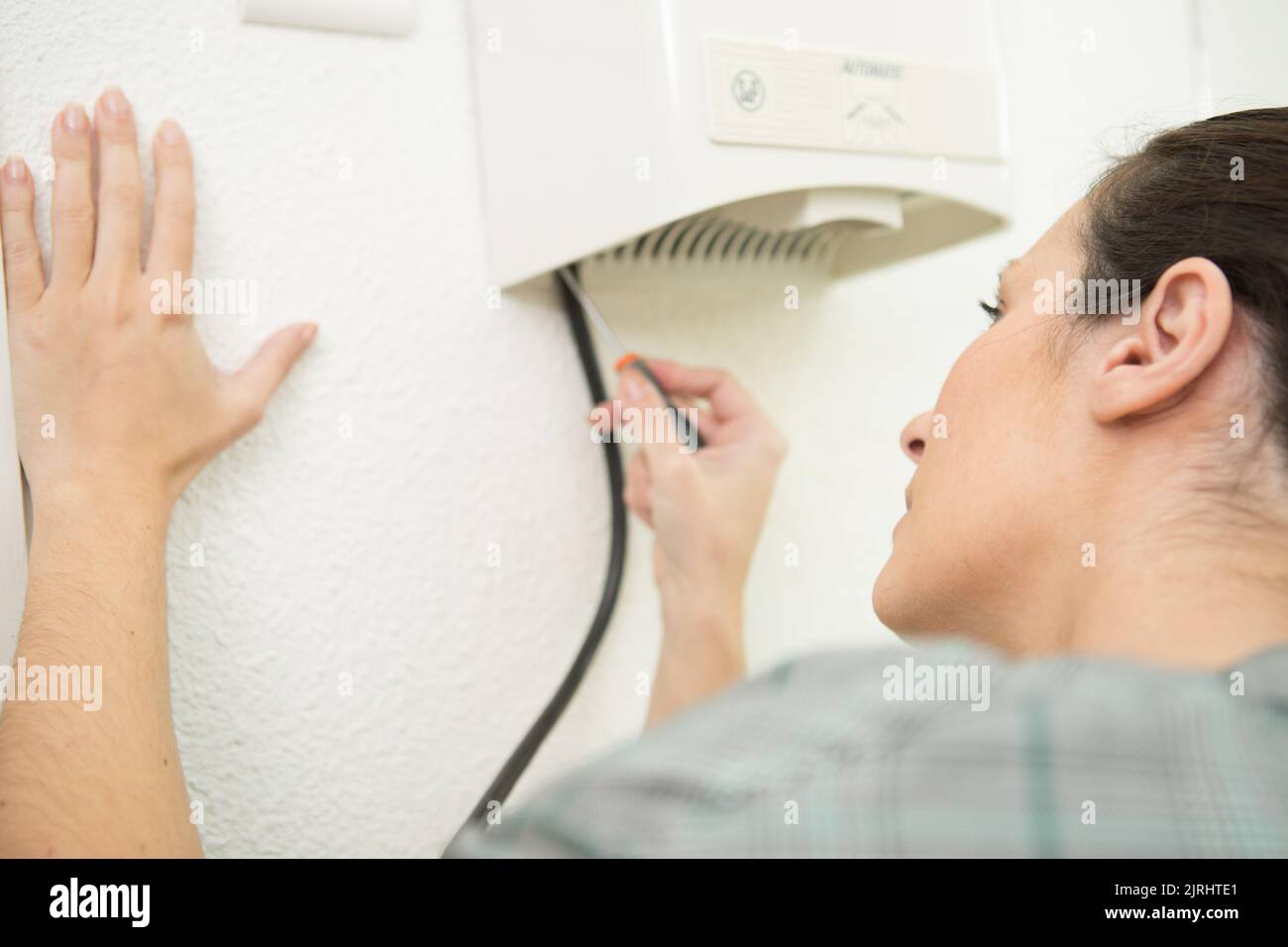 Woman wiring electrical plug hi-res stock photography and images - Alamy