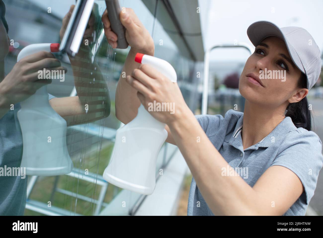 professional woman cleans window exteriors Stock Photo - Alamy