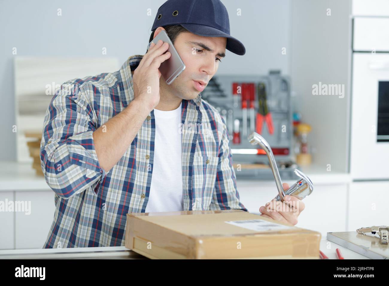 man on a phone call in the kitchen Stock Photo - Alamy