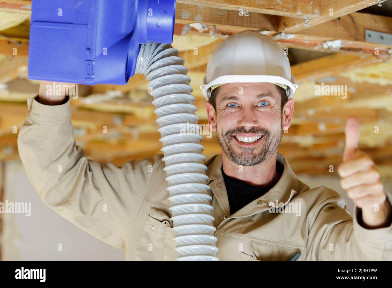 happy builder installing a box Stock Photo - Alamy