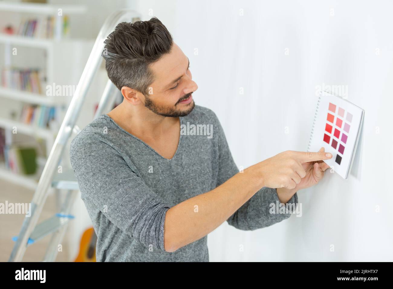 worker holding palette for choosing color of wall closeup Stock Photo ...