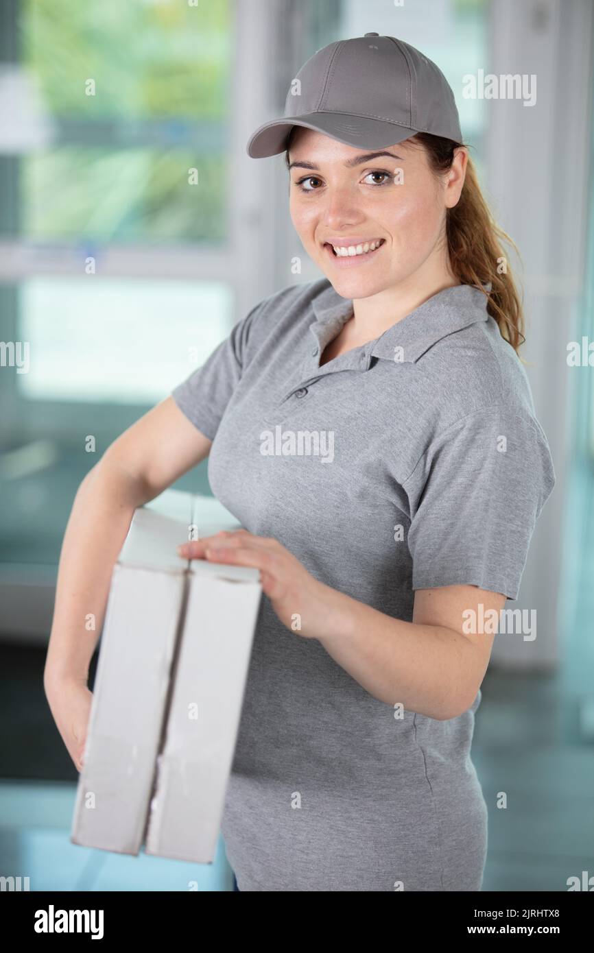 smiling female postal delivery courier woman Stock Photo - Alamy