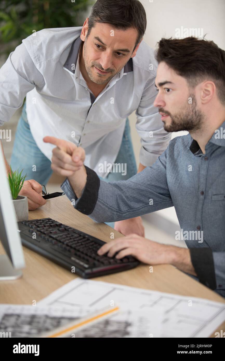 architect is working with his apprentice Stock Photo - Alamy