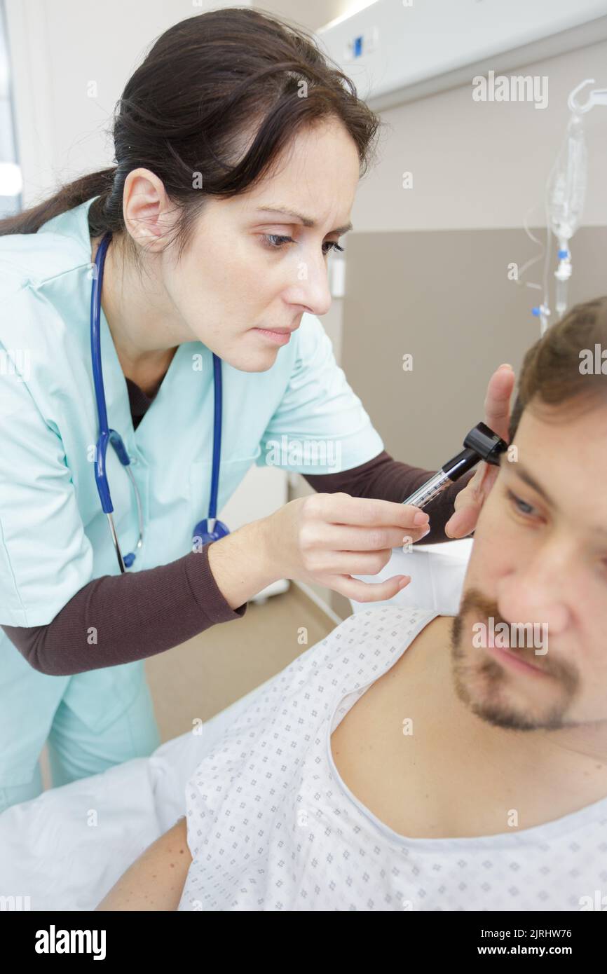 doctor checking patients ear during medical examination Stock Photo - Alamy