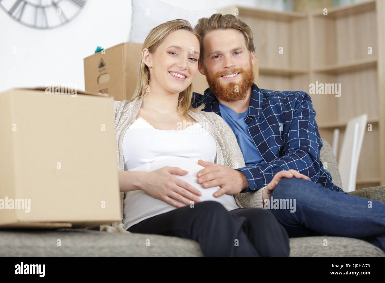 pregnant couple posing with moving boxes Stock Photo - Alamy