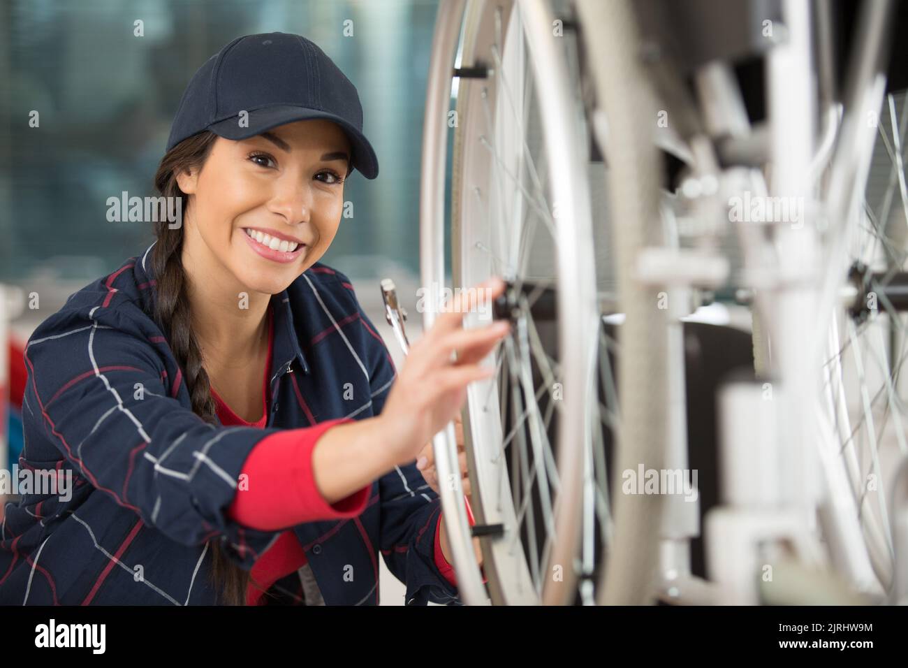 female mechanic servicing a wheelchair in the workshop Stock Photo - Alamy