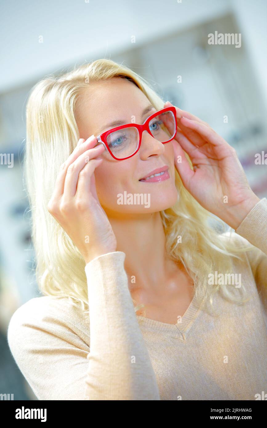 a woman is fitting the eyeglasses Stock Photo - Alamy