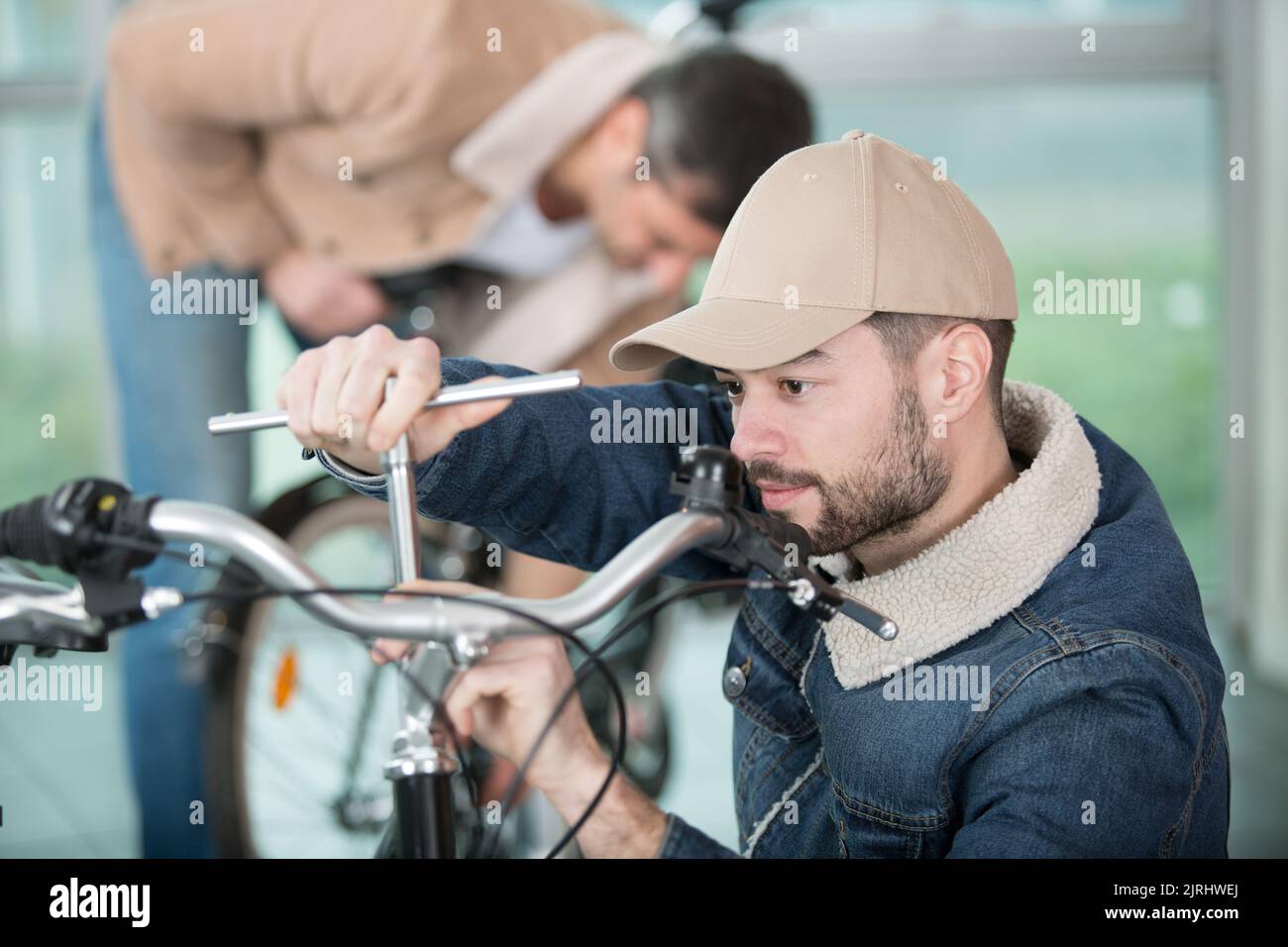 Men fixing bicycles hi-res stock photography and images - Alamy